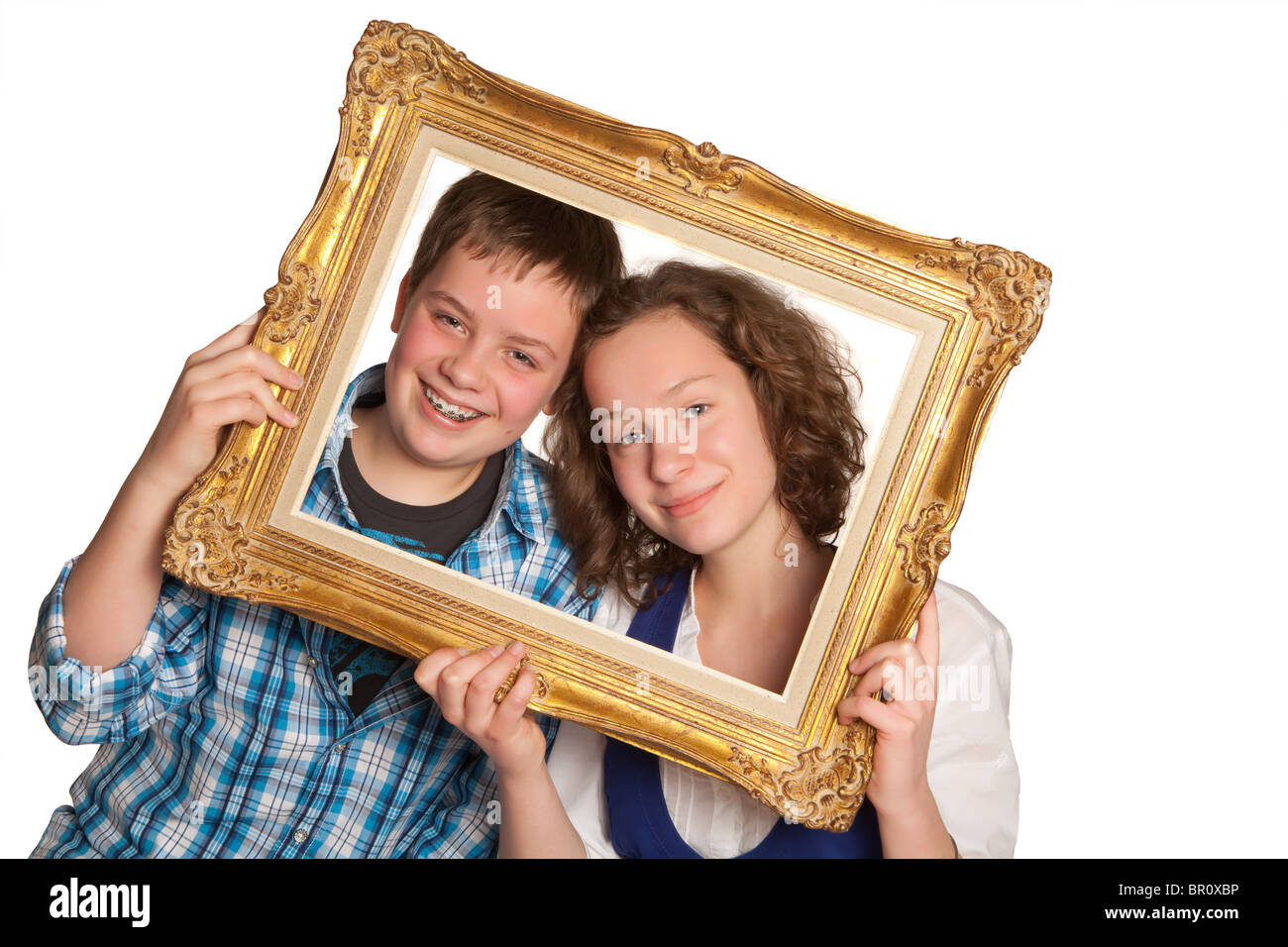 Two teenagers posing holding a picture frame Stock Photo - Alamy