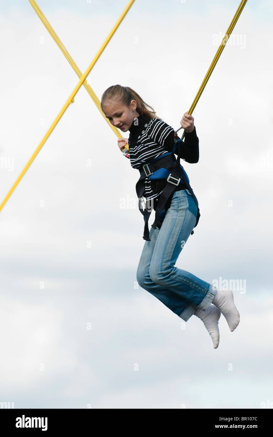 Jumping girl on the power jump ride Stock Photo - Alamy