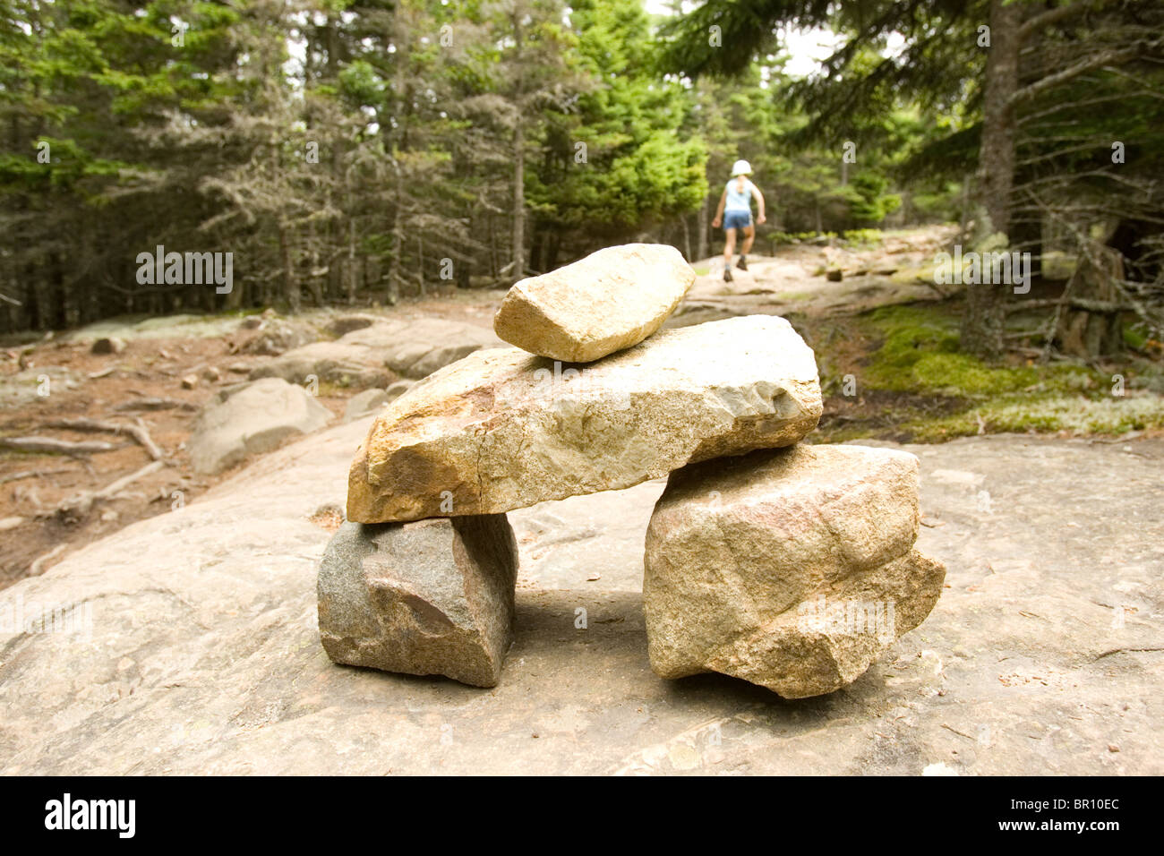 A young girl hikes past a man-made rock formation on the great head ...