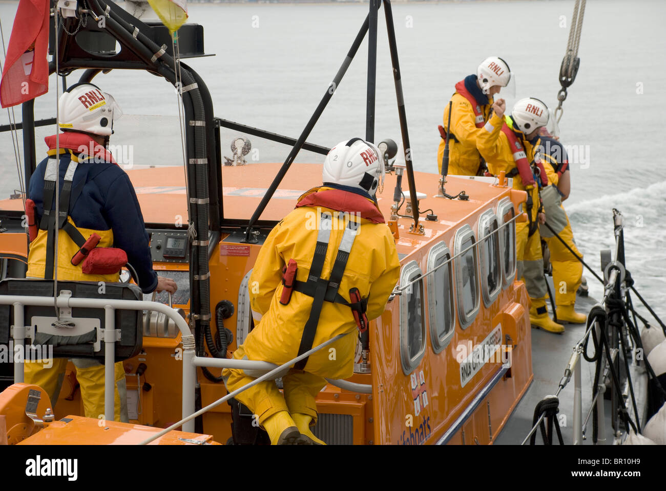 poole lifeboat crew carrying out rescue exercises off bournemouth beach ...