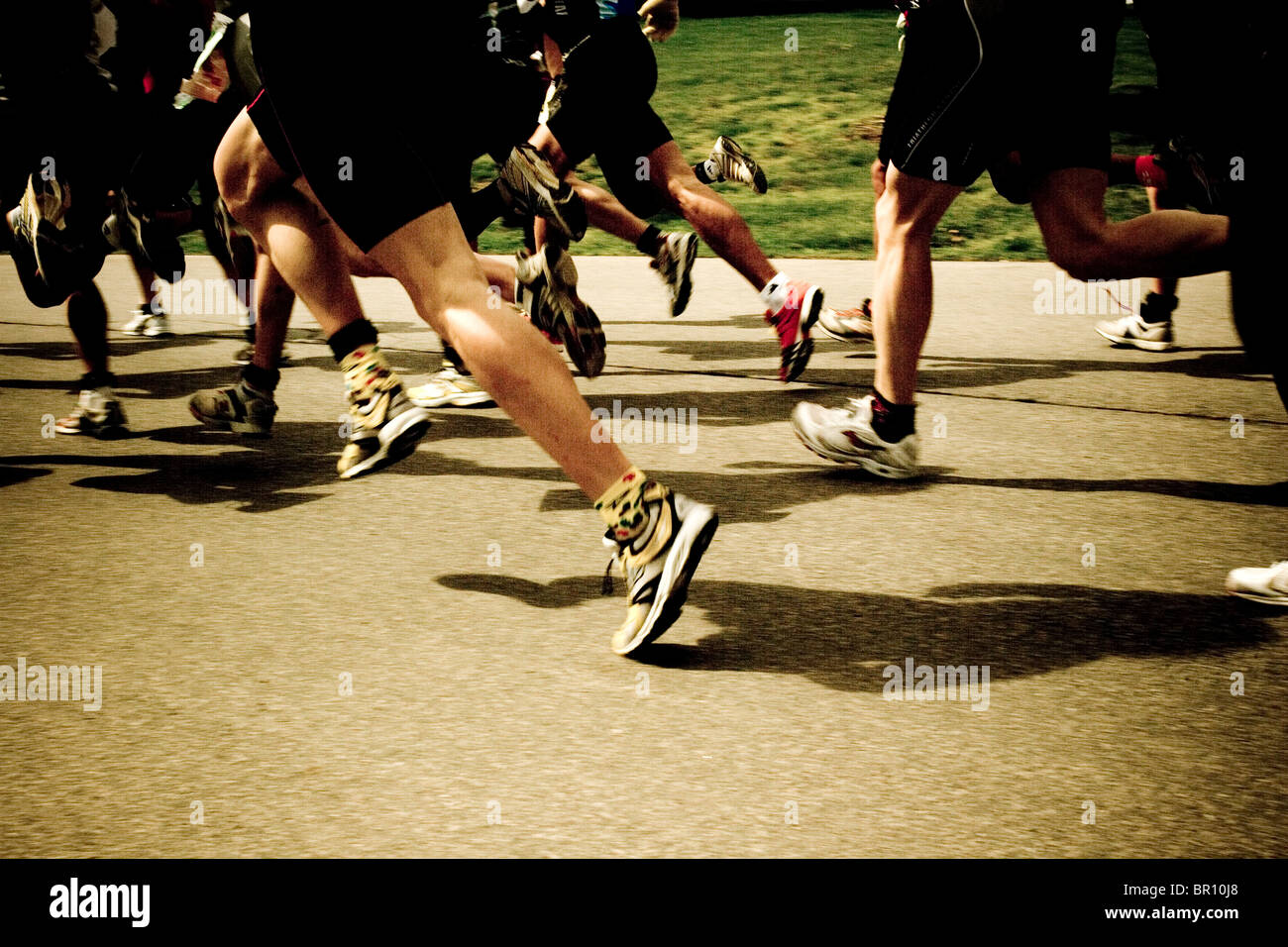 Competitors in a triathlon race sprinting from the start line in ...