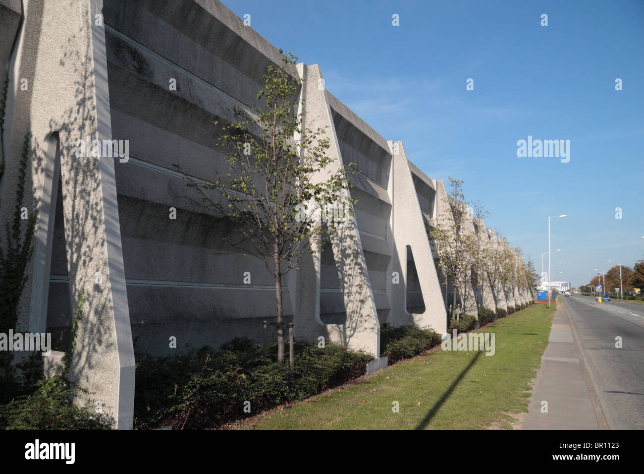 A 20 foot high concrete barrier on the roadside of the southern ...