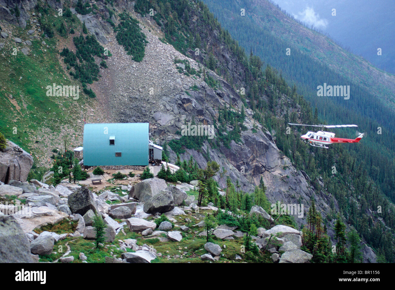 Helicopter comes in to land at the Konrad Kain Hut in the Bugaboo ...