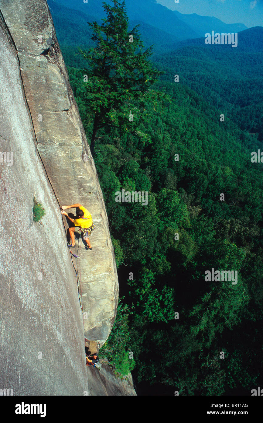 Two men rock climbing on a large granite face in North Carolina Stock ...