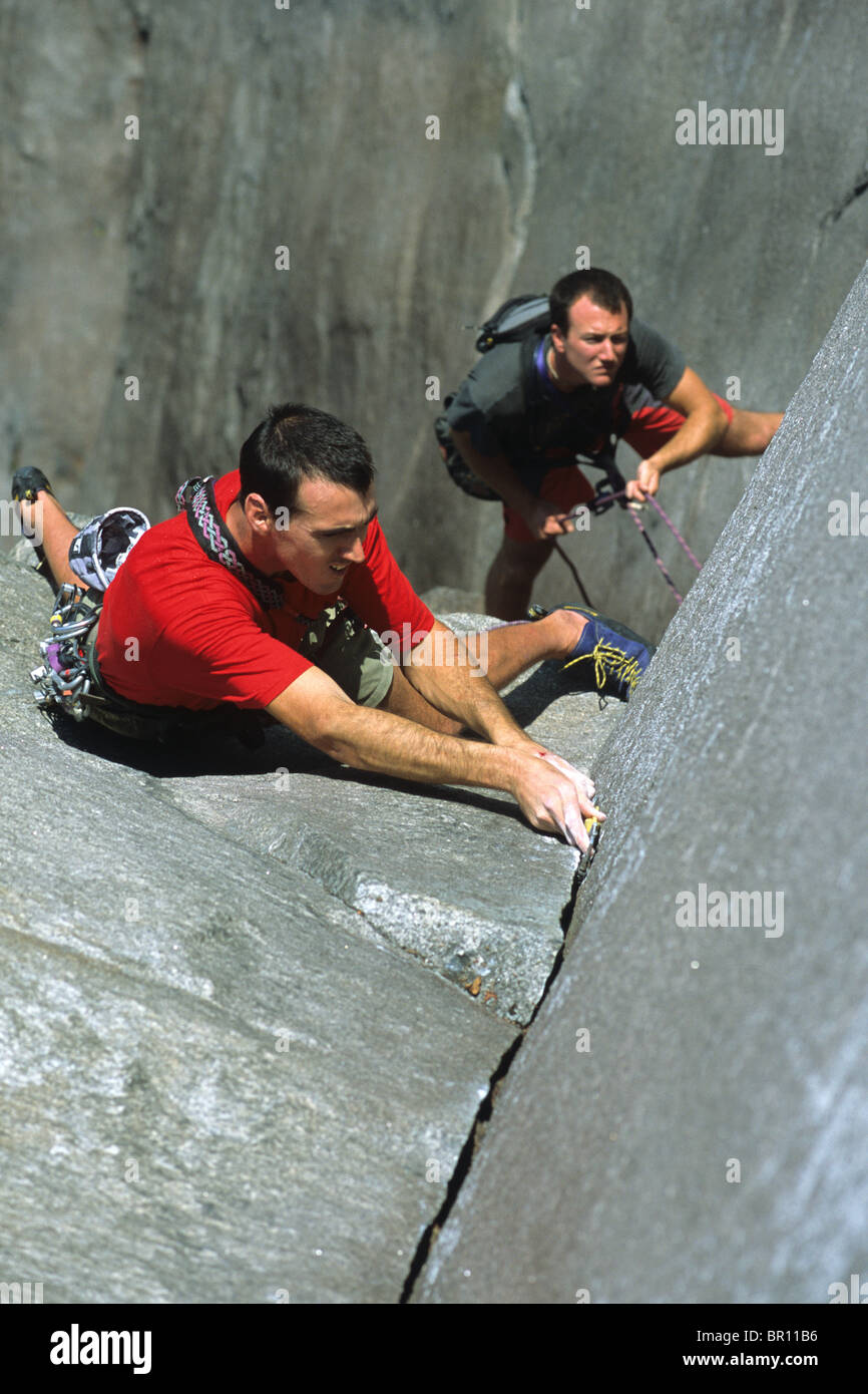 Two men rock climbing on a large granite face in North Carolina Stock ...