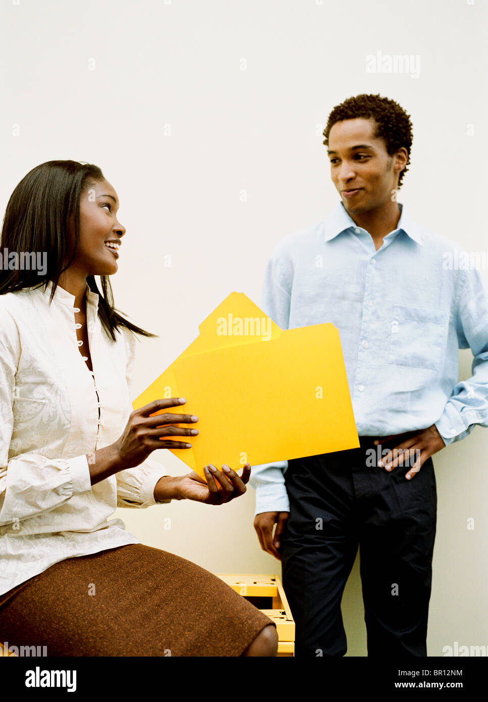 Business people discussing file folders Stock Photo - Alamy