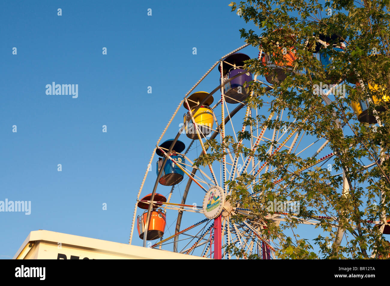 A small ferris wheel on a bright sunny day. Canada Day Carnival in the ...