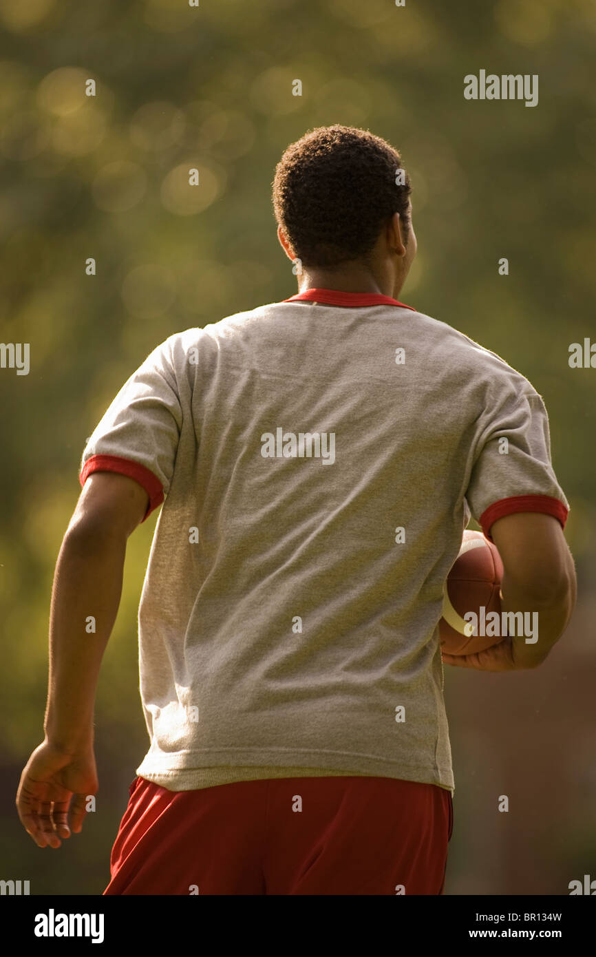 Running the football hi-res stock photography and images - Alamy