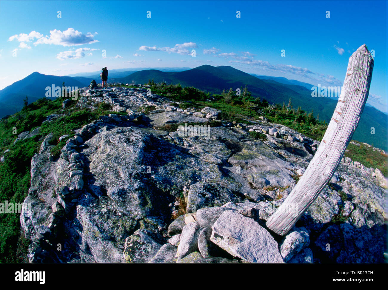 A hiker admires the view from the summit of Sunday River White Cap ...