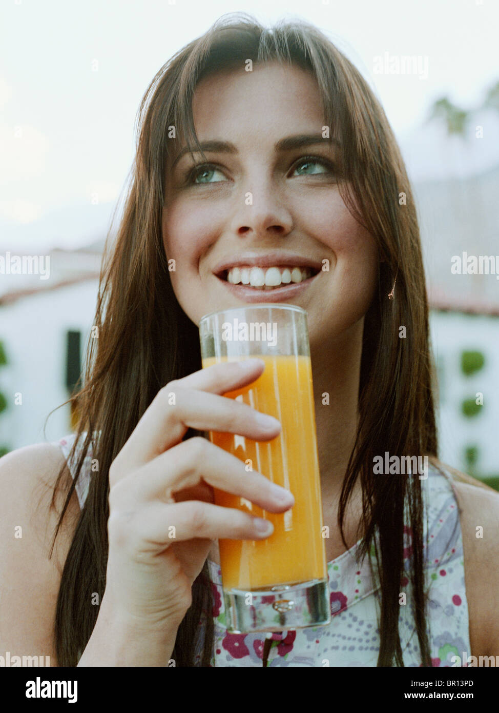 Woman drinking orange juice Stock Photo - Alamy