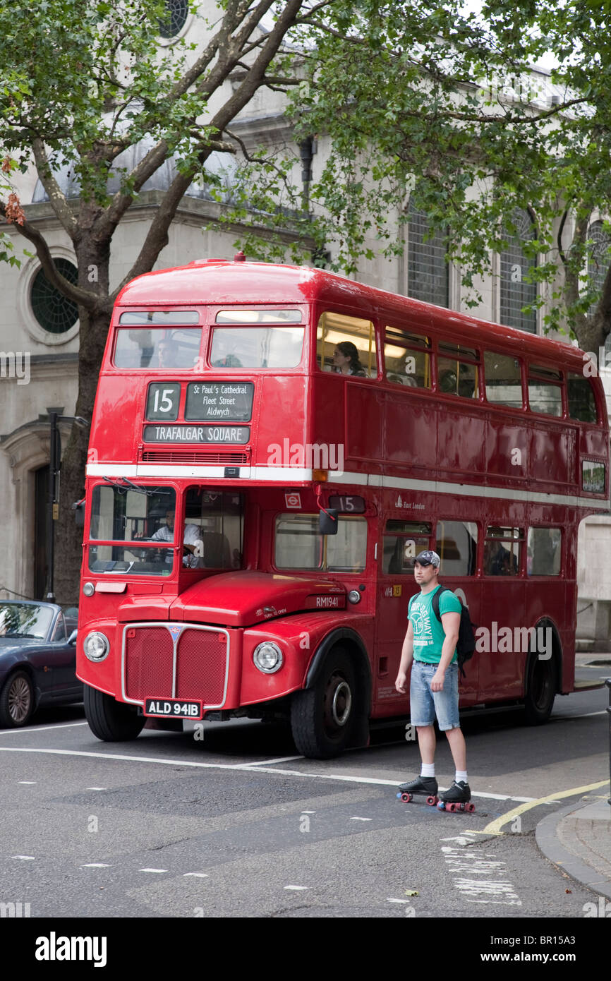 Traditional Red Bus with Rollarskater in Central London Stock Photo - Alamy