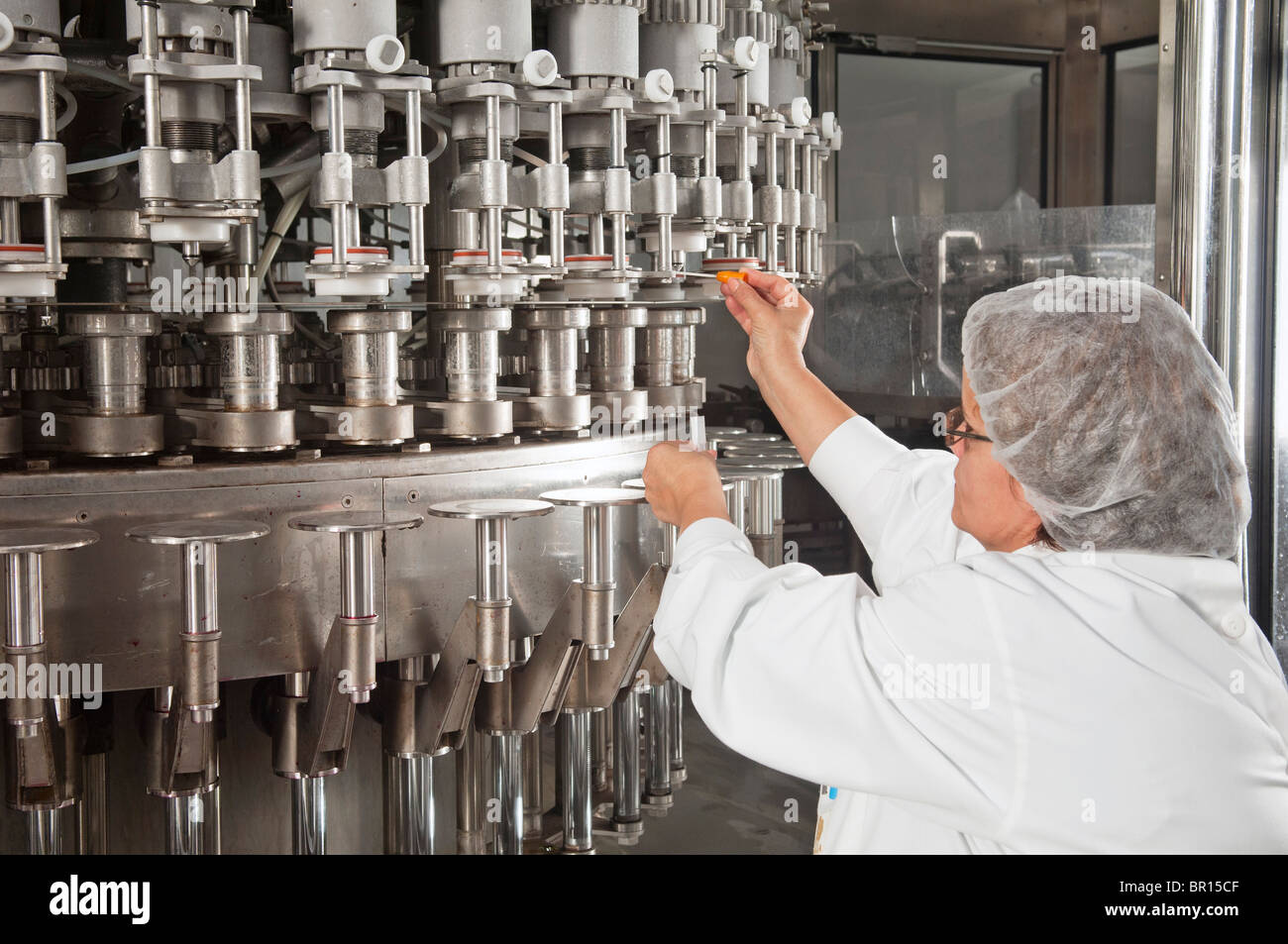 Quality control woman collecting wine sample in Adega Cooperativa de ...