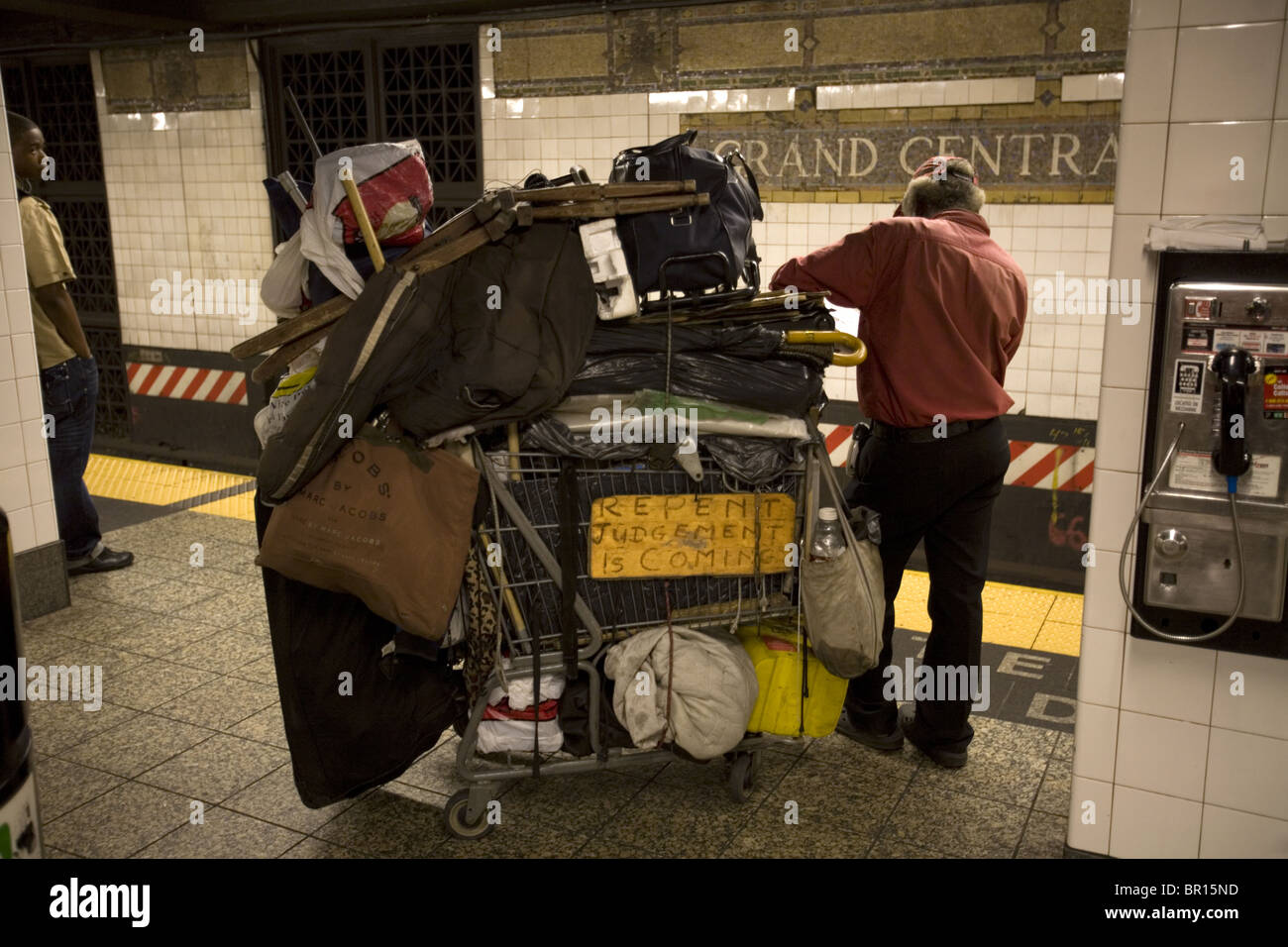 Homeless man with his belongings on the subway platform in the Grand ...