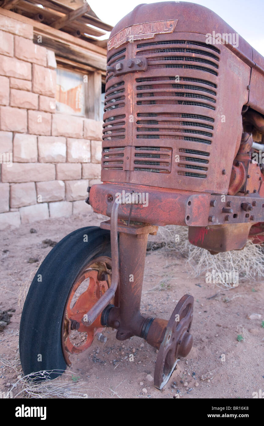 Abandoned old crank start Farmall tractor at abandoned farm building ...