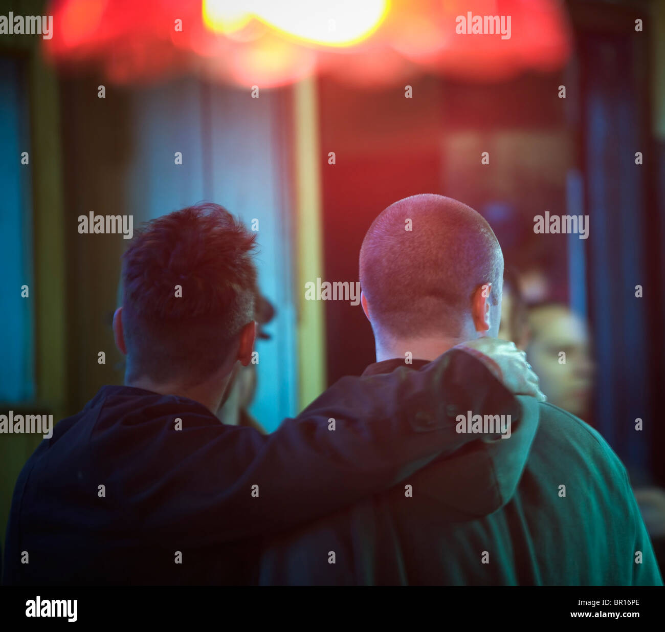 A man with his arm over the shoulder of another man Stock Photo - Alamy