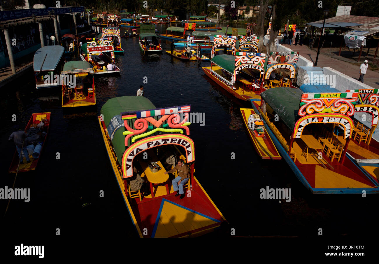 Tourists ride in a boat through the water canals of Xochimilco on the ...