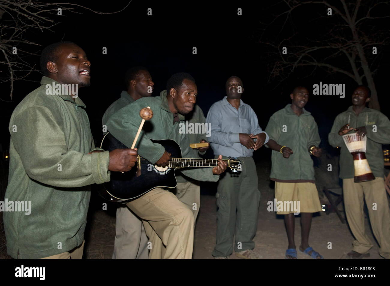 Lodge staff band playing music at a campfire, Serengeti National Park ...