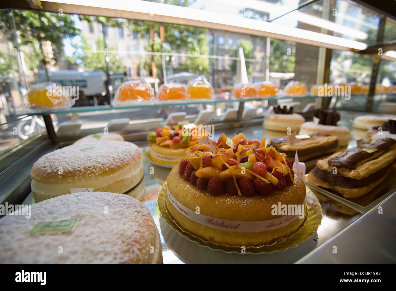 Cakes in a window display facing street Stock Photo - Alamy