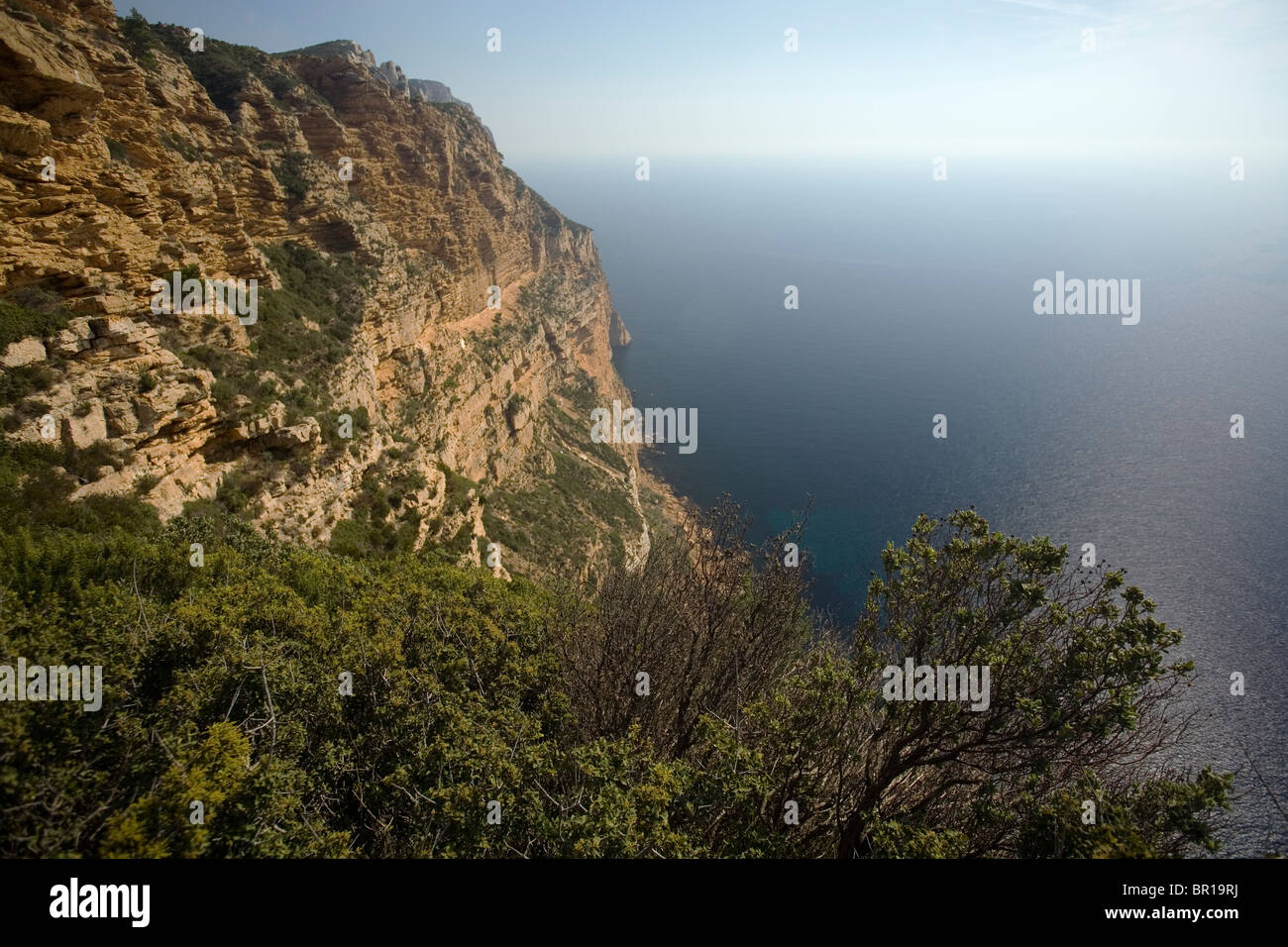 Red or Orange Sea cliffs above the ocean Stock Photo - Alamy