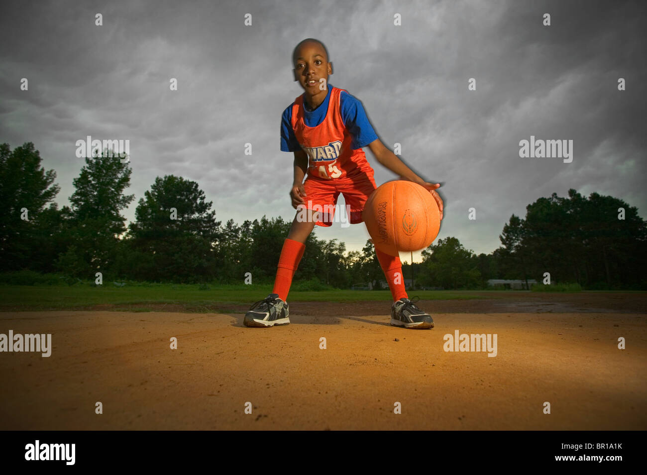 Young boy plays basketball in East Texas. (fill flash Stock Photo - Alamy
