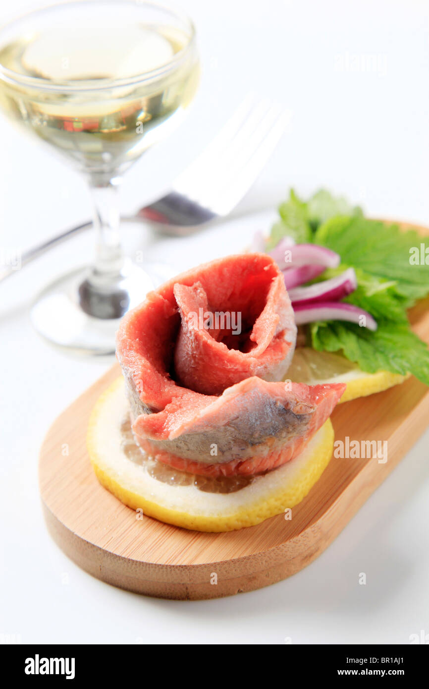 Fish hors d'oeuvre and a glass of white wine Stock Photo - Alamy