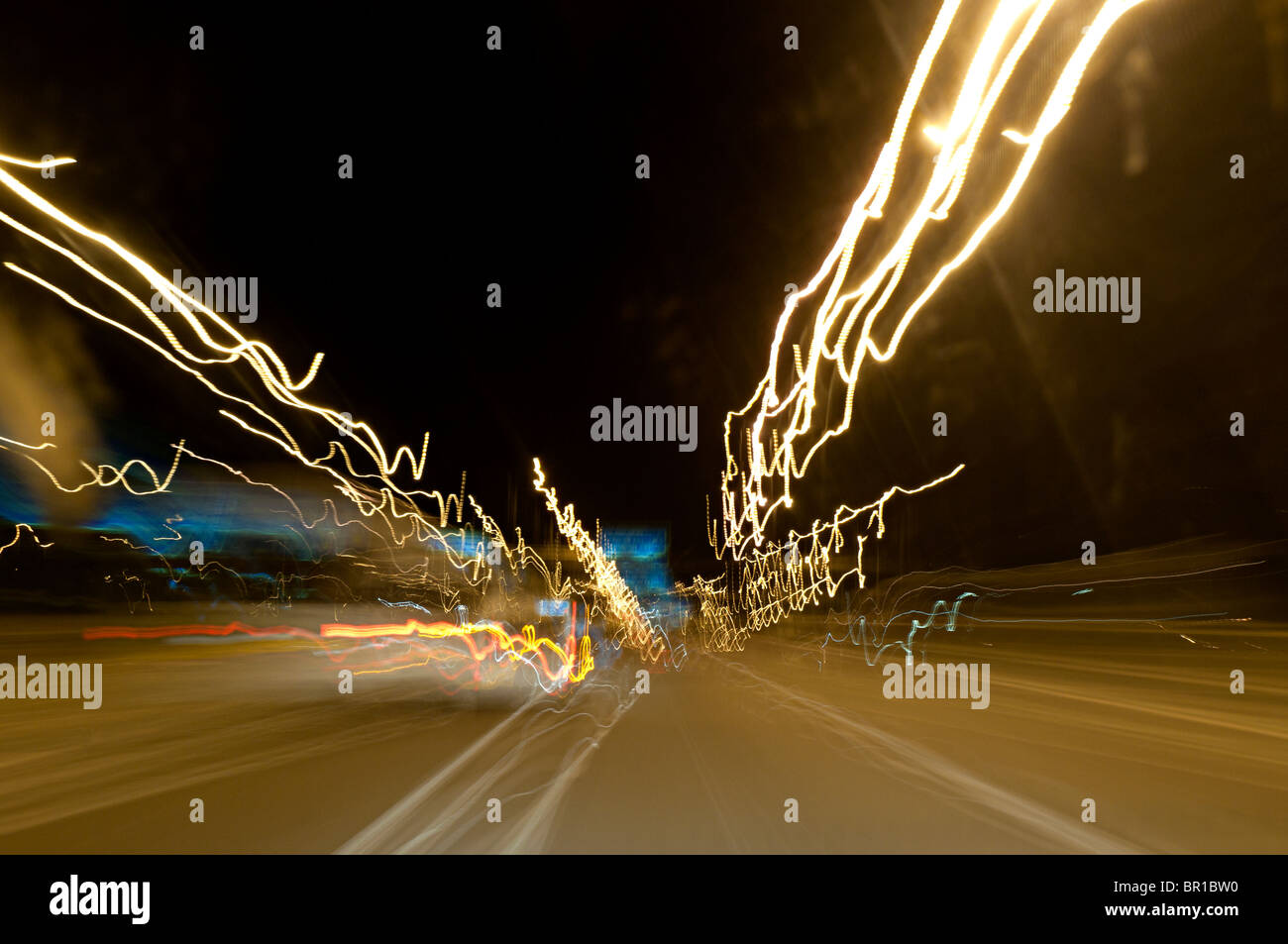 Car headlights on a nighttime street hi-res stock photography and ...