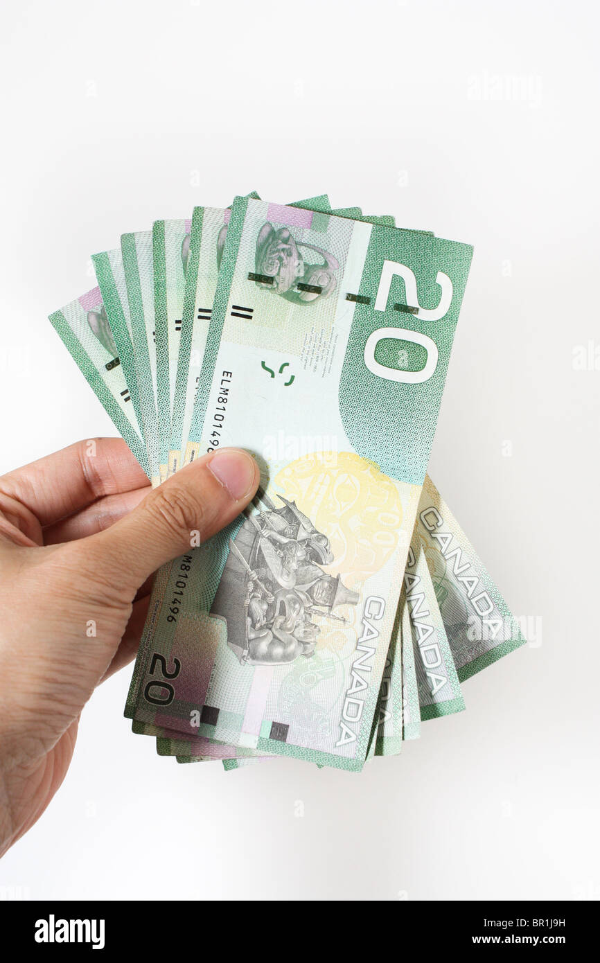 hand holding money canada canadian twenty dollars Stock Photo - Alamy