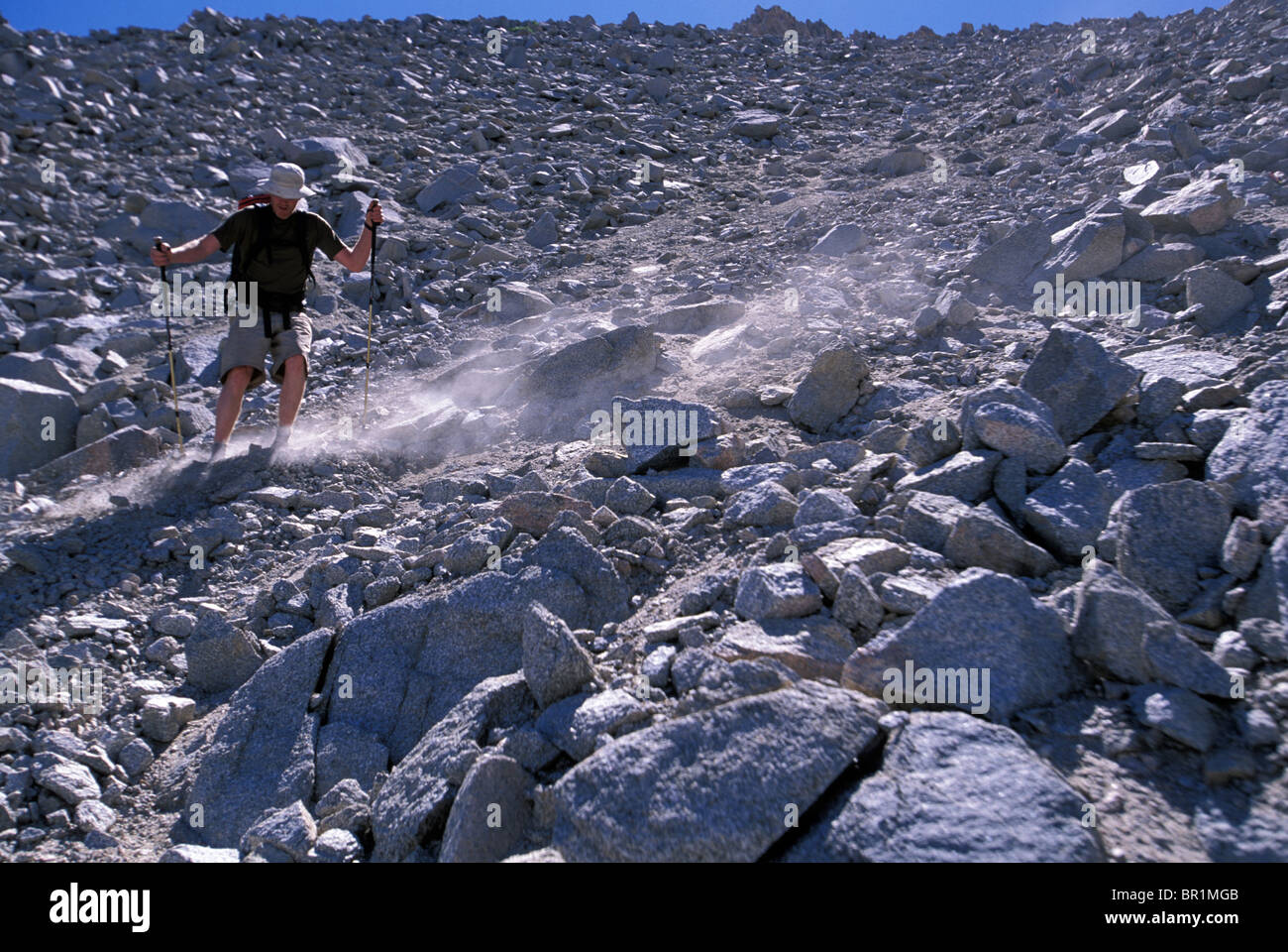 Adventurous hiker trekking down boulders hi-res stock photography and ...