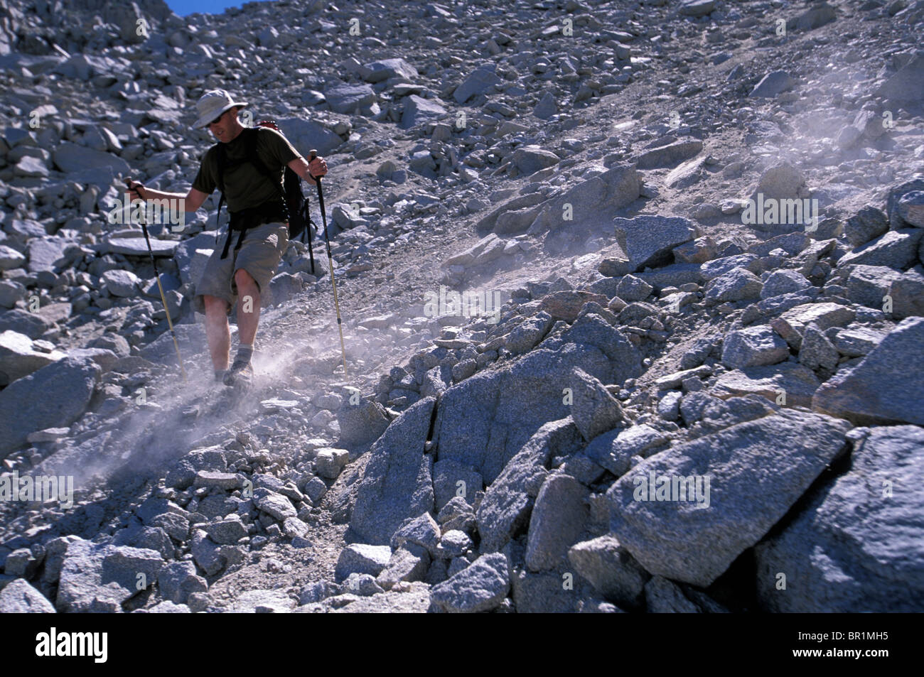 Adventurous hiker trekking down boulders hi-res stock photography and ...