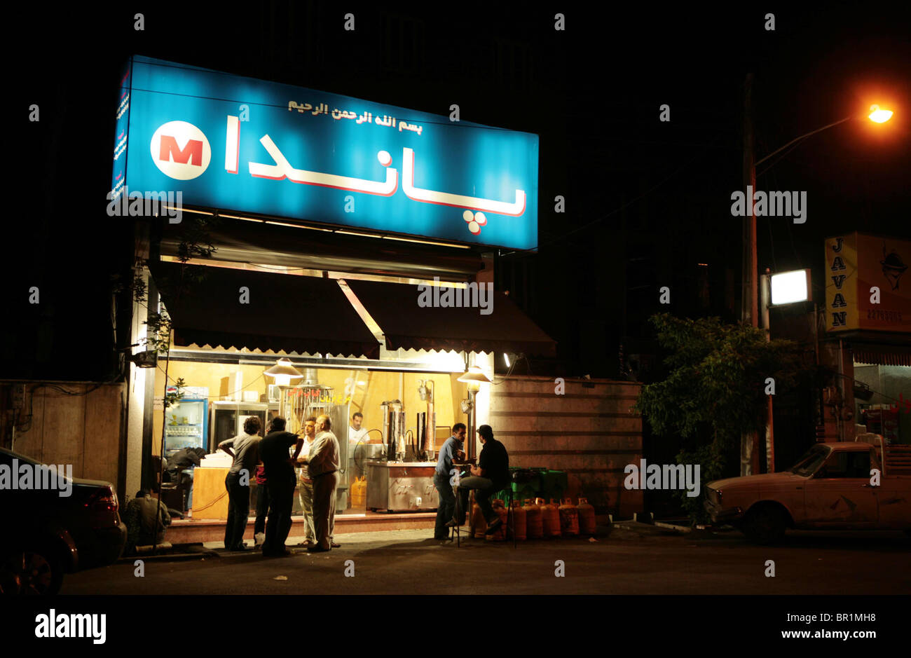 A group of men have a late night kebab at a takeaway in Tehran Iran ...