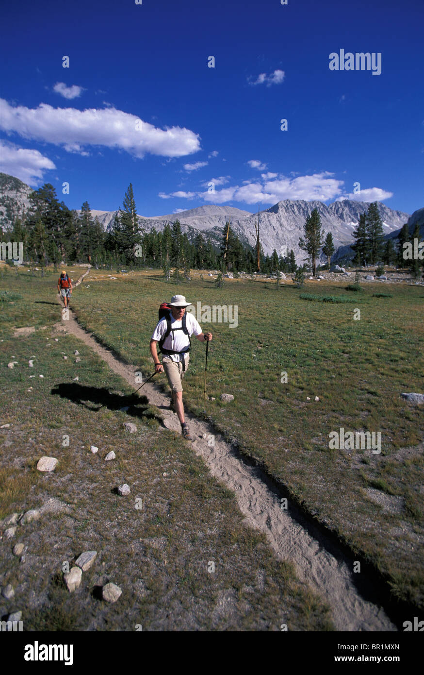 Two backpackers on a trail in eastern Sierra Nevada mountains ...