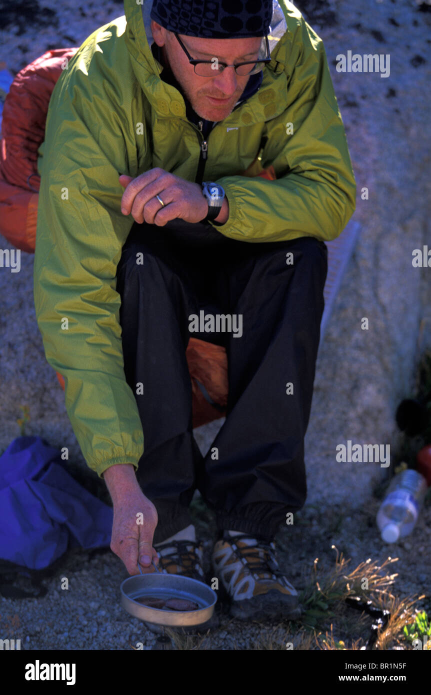 Man eating out of a small bowl in eastern Sierra Nevada mountains ...