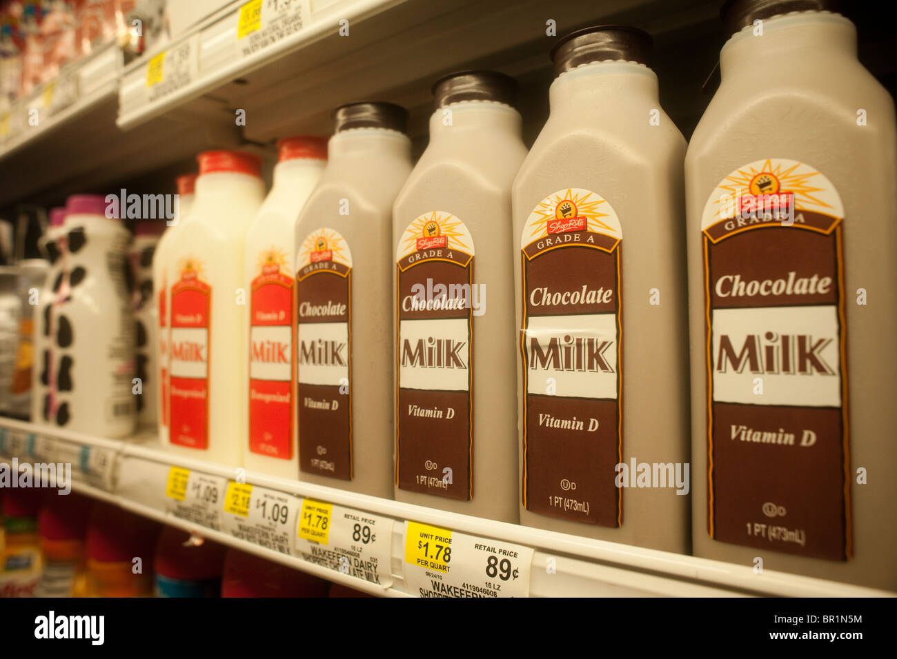 Containers of chocolate flavored milk in a supermarket refrigerator ...