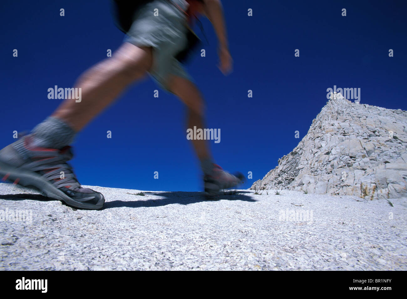 Feet with trail running shoes hiking by in eastern Sierra Nevada ...