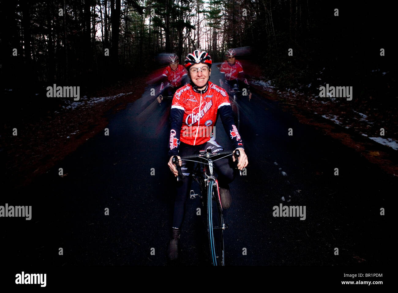 Three women cycling on a road Stock Photo - Alamy