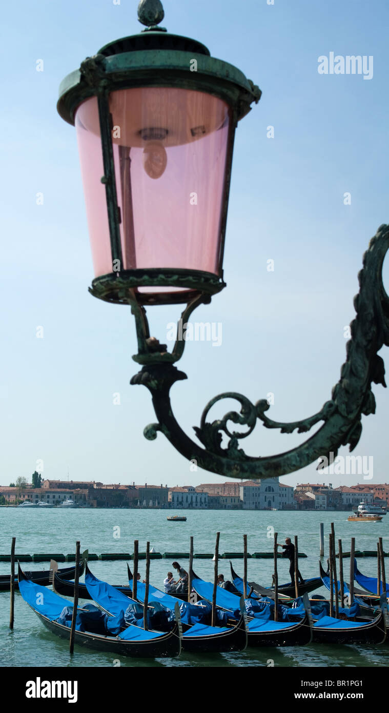 Lamp post over looking gondolas in Venice Stock Photo - Alamy