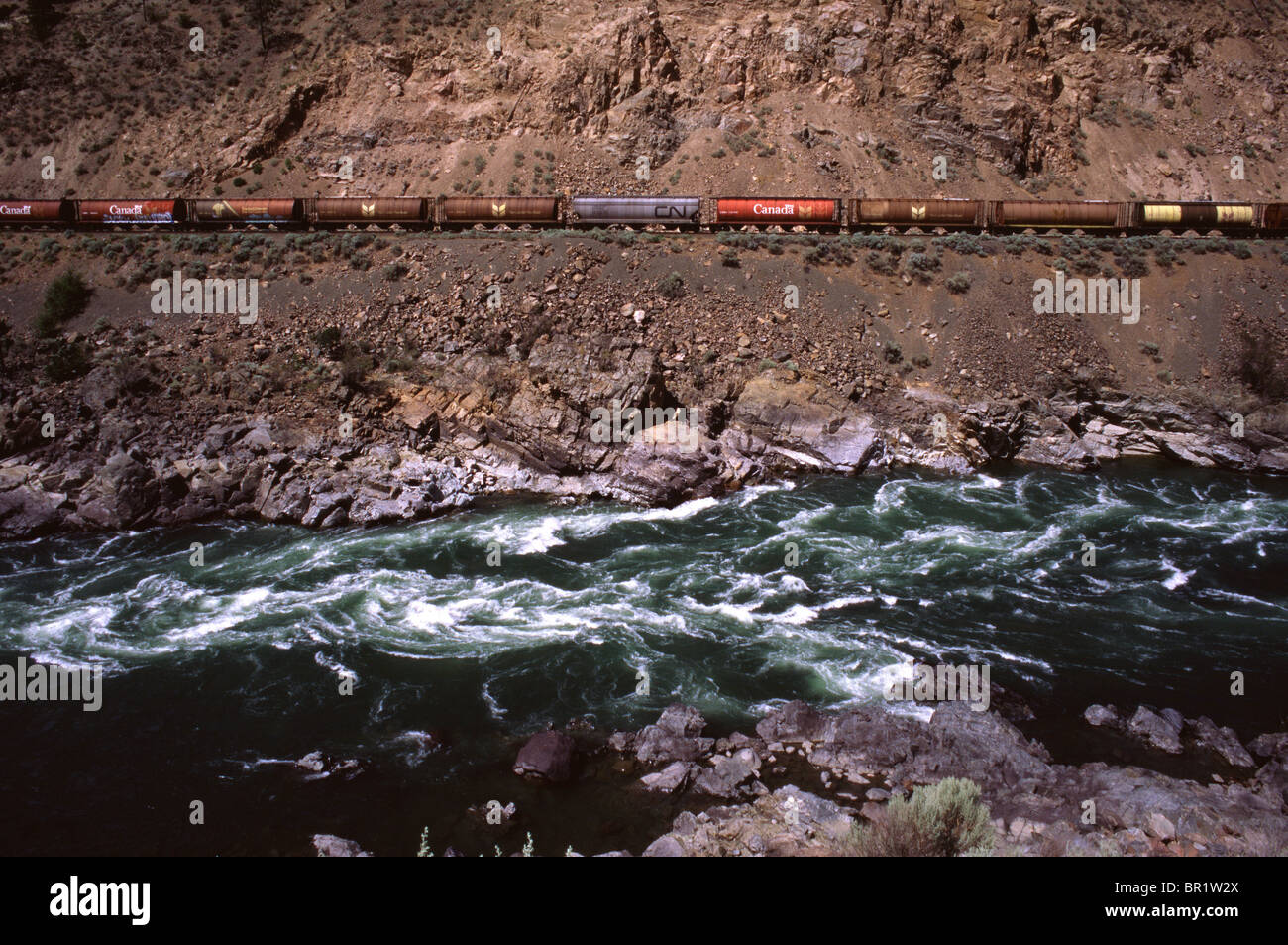 Cargo train through the Fraser river Canyon Stock Photo - Alamy