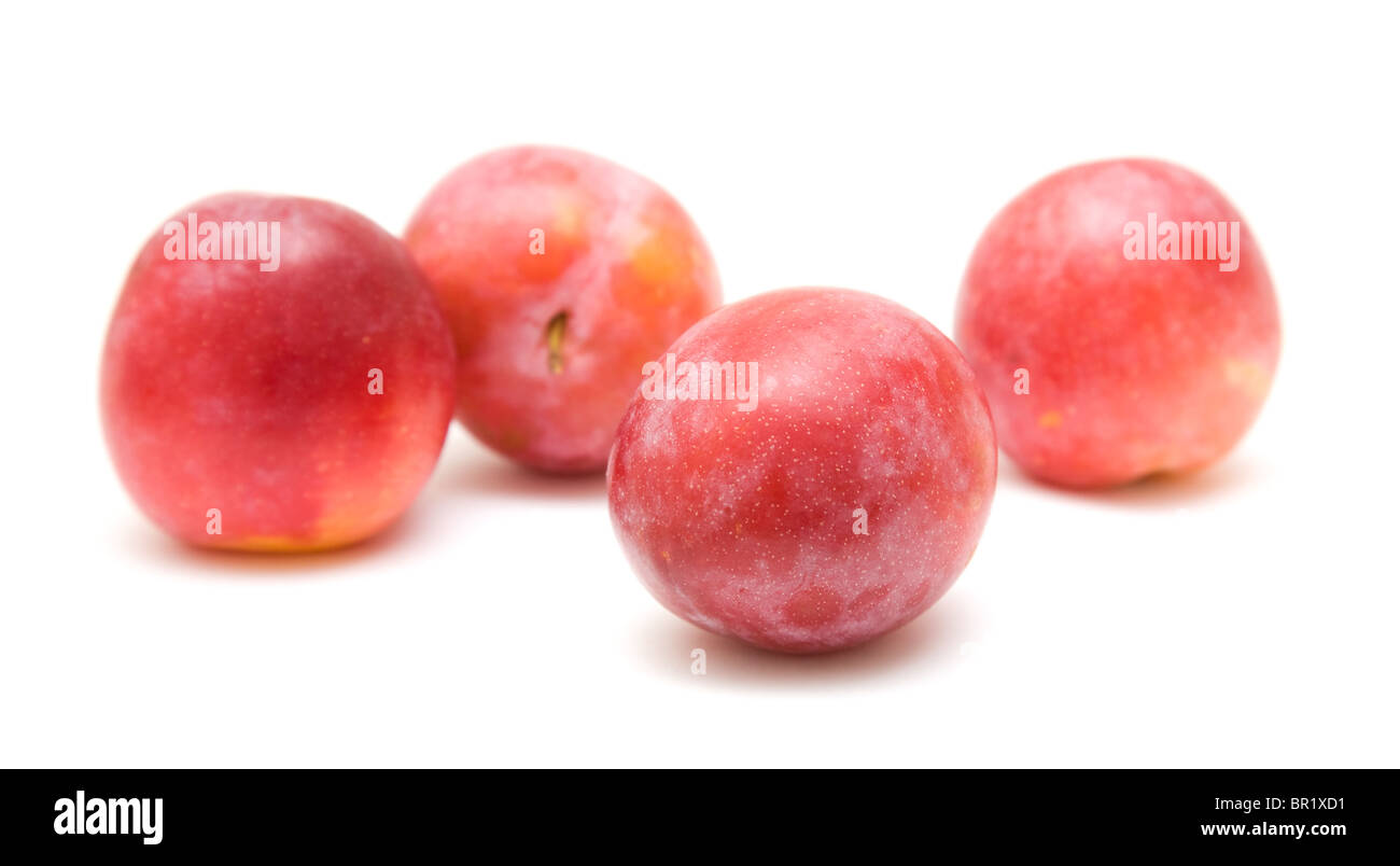 light red ripe large plums; four fruits; isolated on white background ...