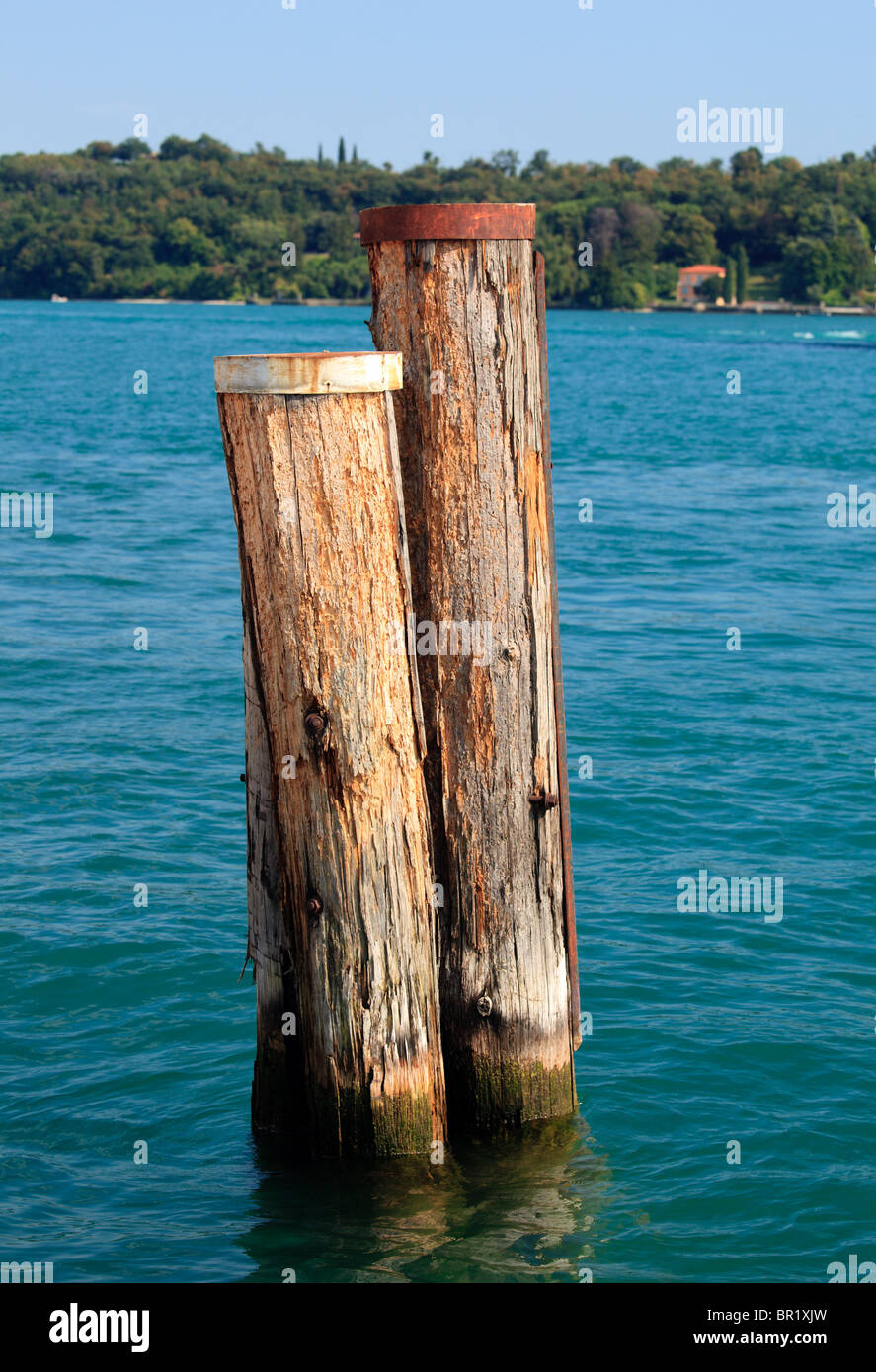 Wood mooring posts in Lake Garda in Italy Stock Photo - Alamy