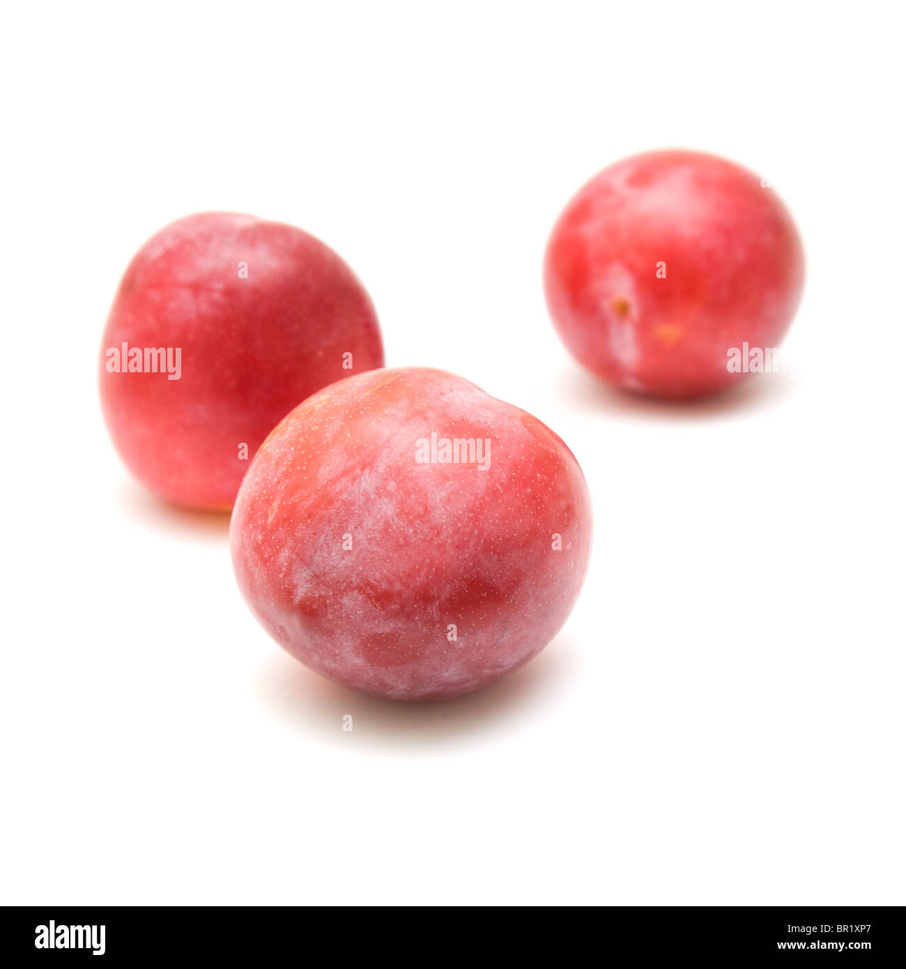 light red ripe large plums, three fruits, isolated on white background ...