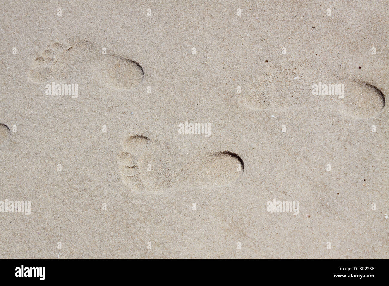 Feet marks on a beach Stock Photo - Alamy