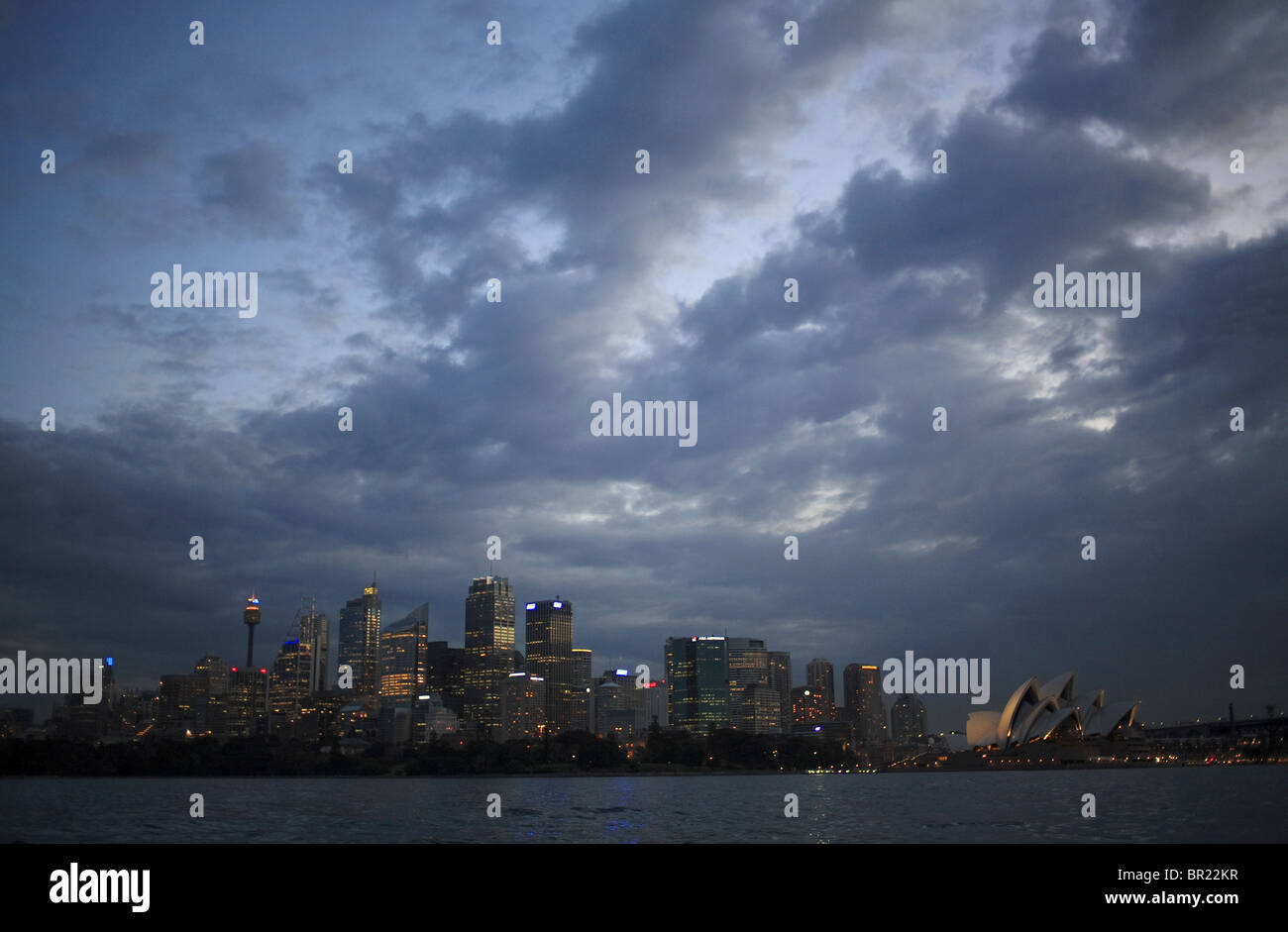 the buildings of downtown Sydney, Australia, at dusk. Image is dark ...