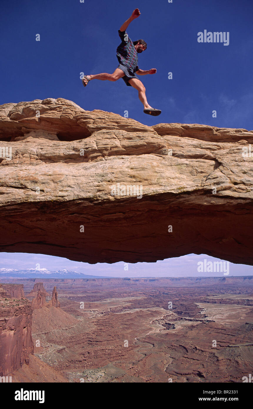 Cliff Leight, a desert adventurer, leaps above Mesa Arch Stock Photo ...