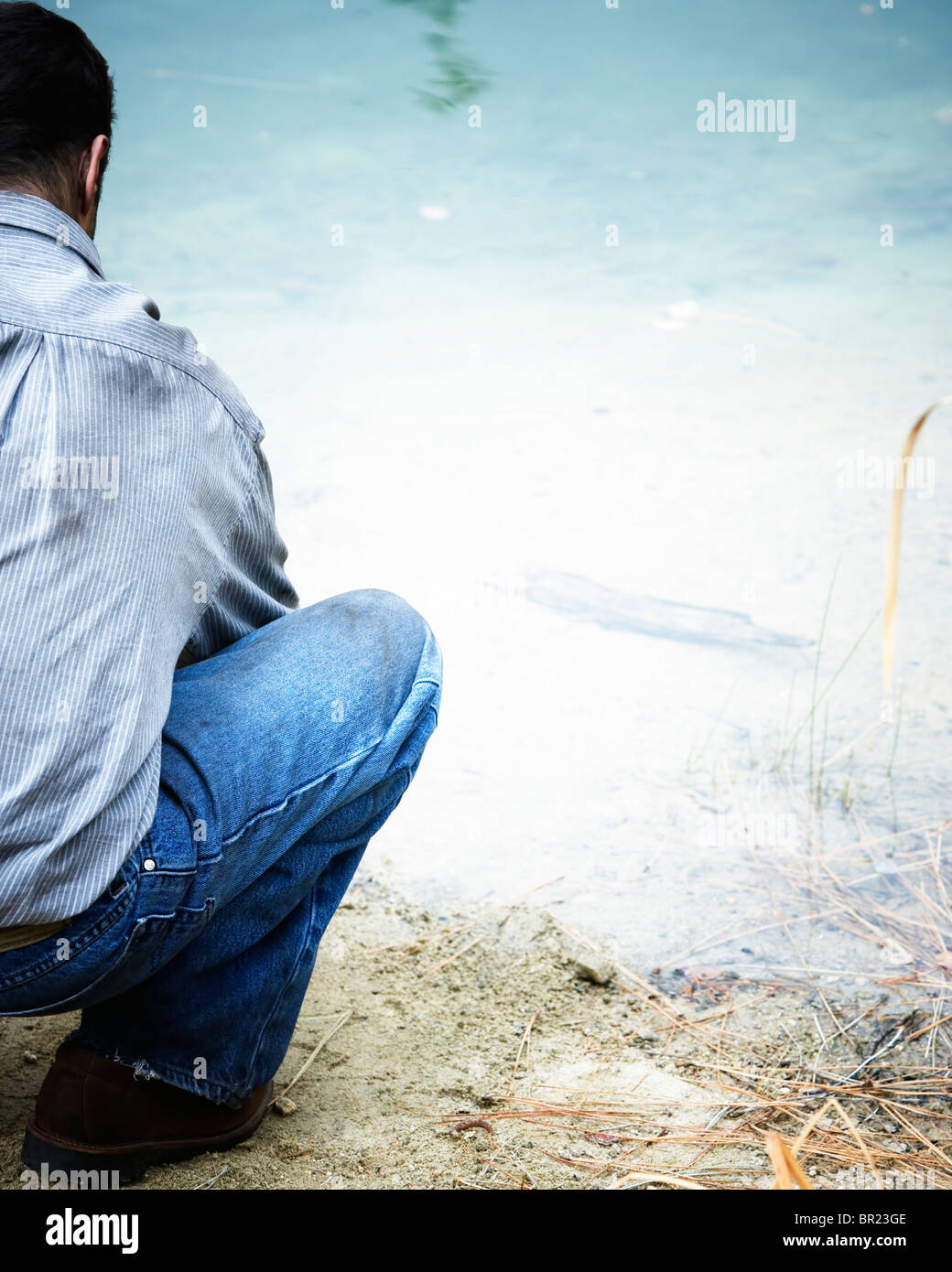 Man squatting rear view hi-res stock photography and images - Alamy