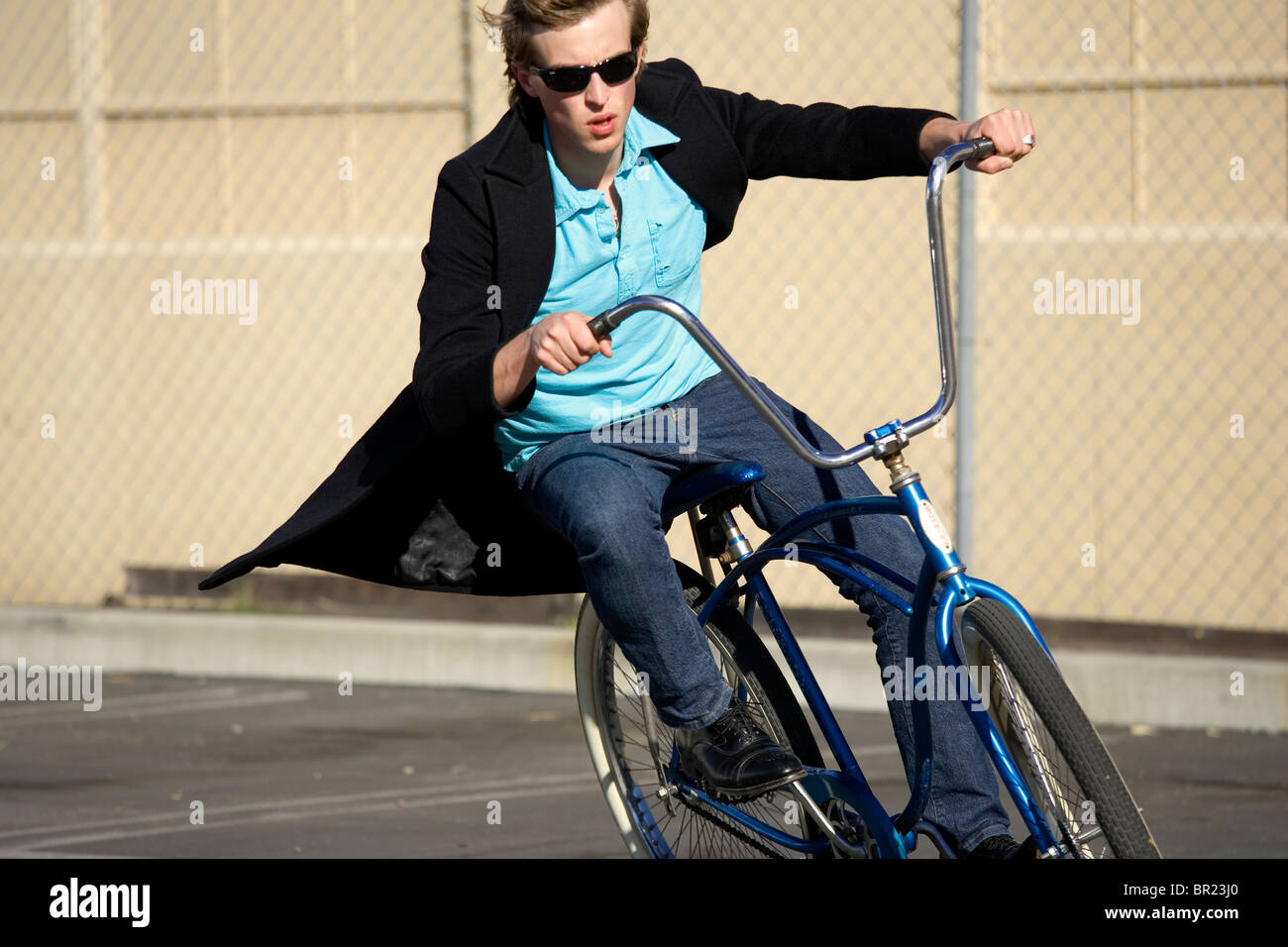 A male model riding a bicycle during a photo shoot in Los Angeles, USA ...
