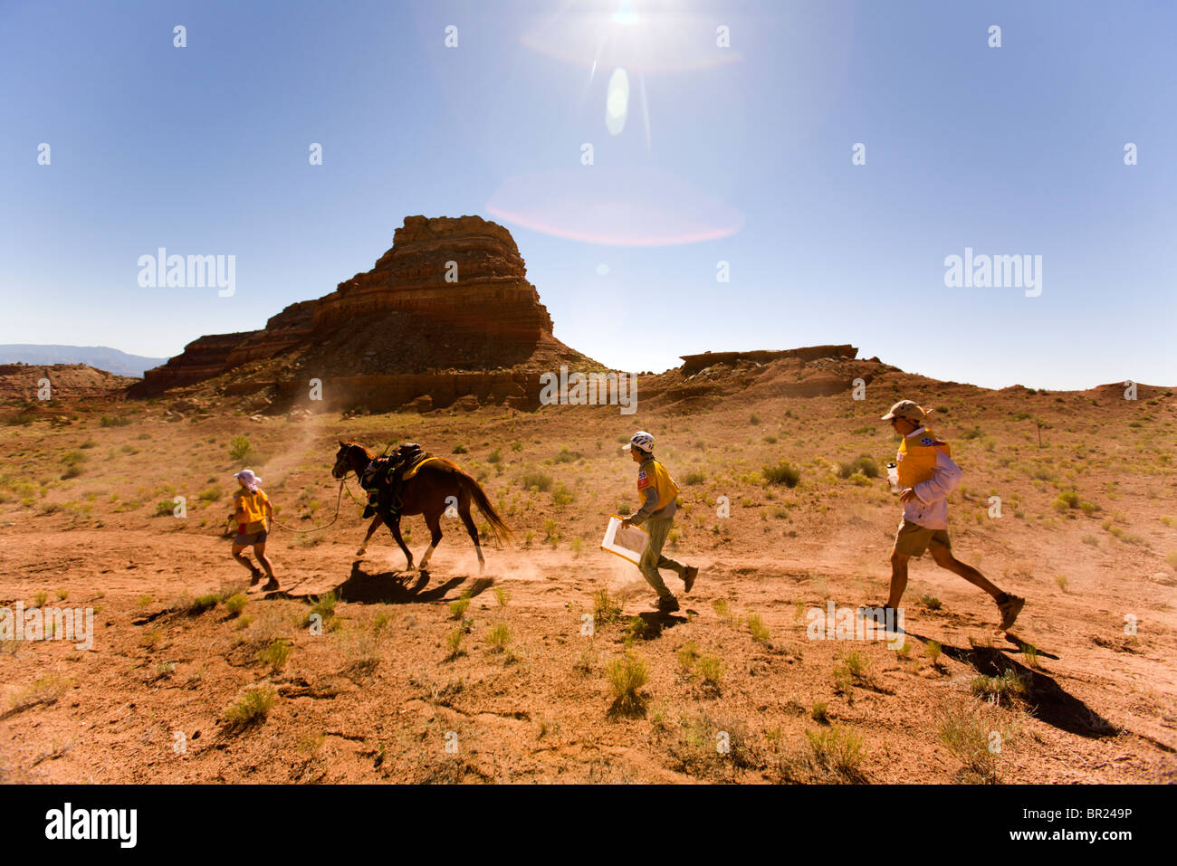 Team running with a horse in the desert during an adventure race near ...