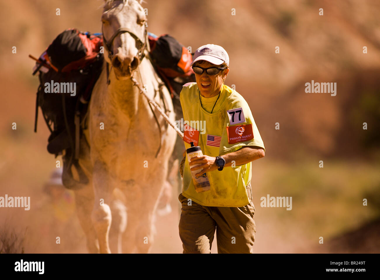 adventure racer running and leading a horser in a race in Moab, Utah ...