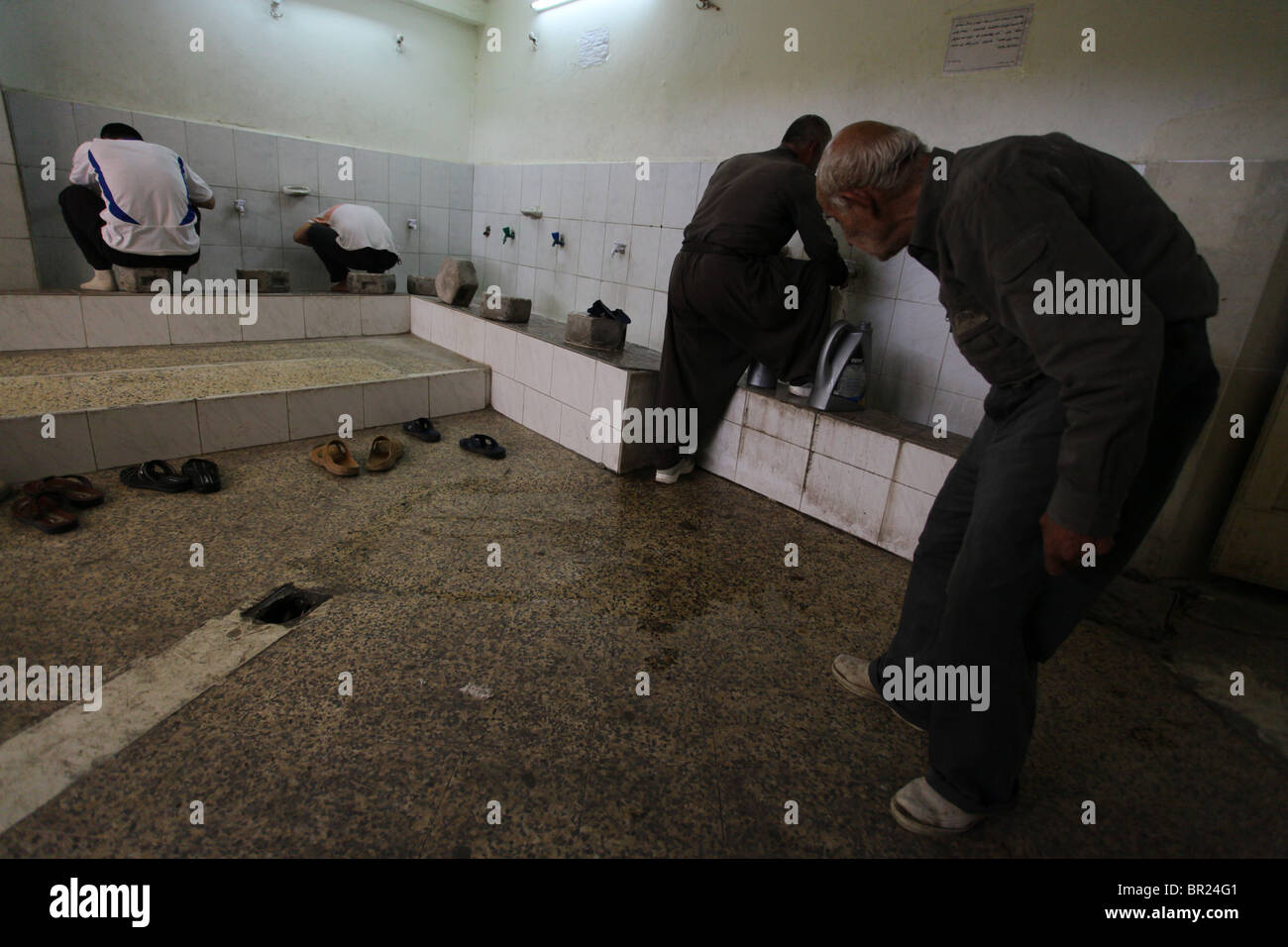 Kurdish men washing their feet in a public bathroom in Qaysari bazaar ...