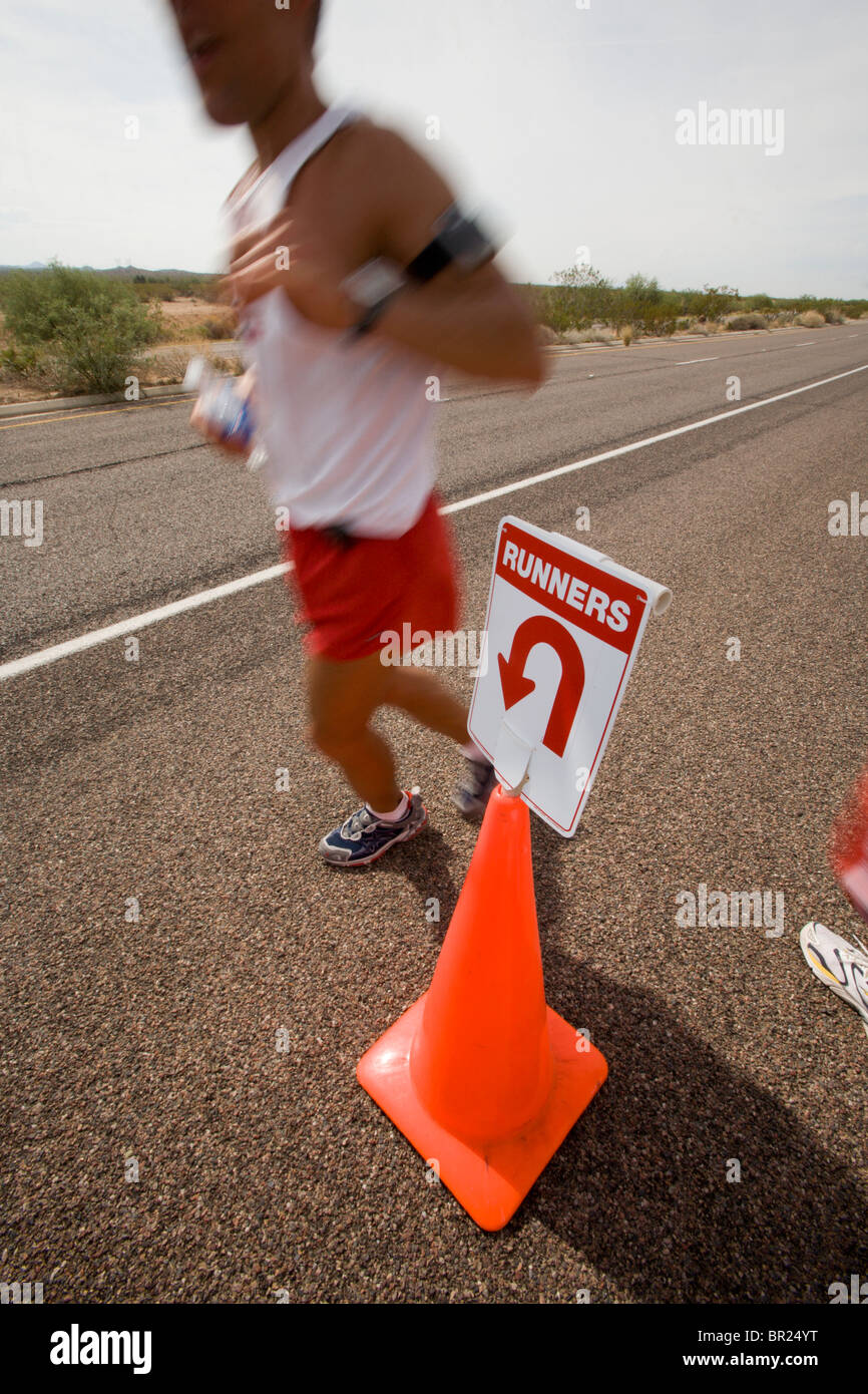 Man running around the turn around cone in a marathon in Surprise ...