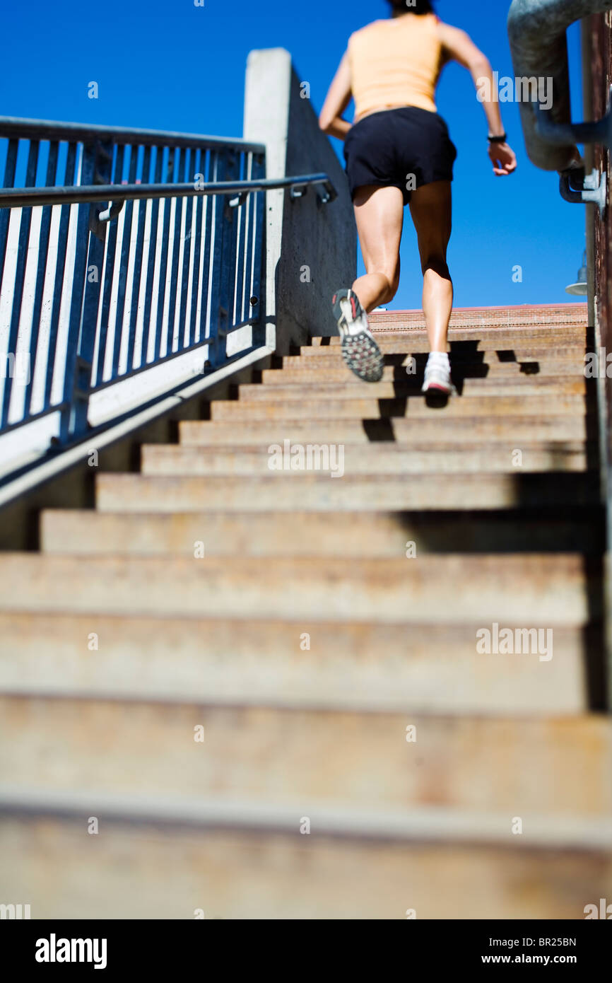 Fit woman dashing up stairs Stock Photo - Alamy